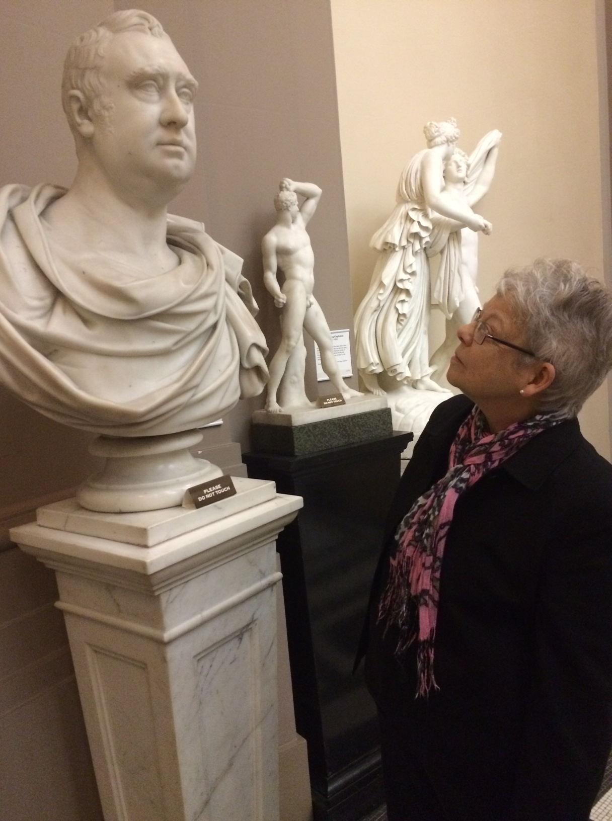 Mary Lou admiring a portrait bust – The Educated Traveller